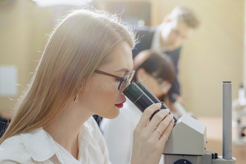 Two Girls and a Boy Work with Microscopes Stock Photo - Image of ...