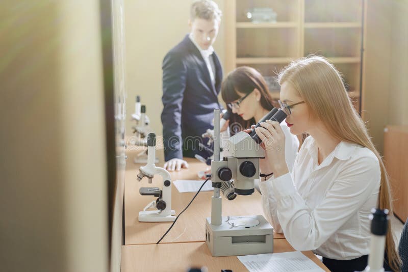 Two Girls and a Boy Work with Microscopes Stock Photo - Image of health ...