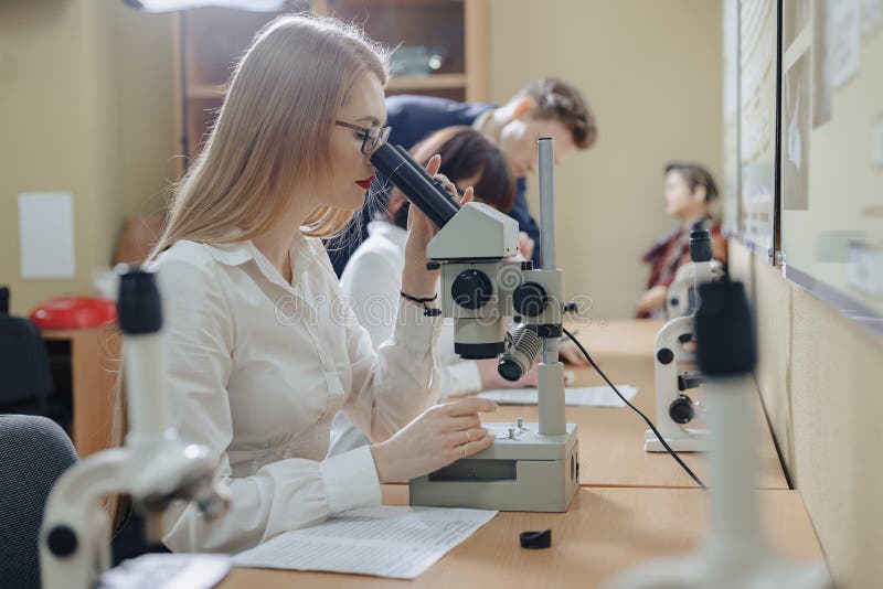Two Girls and a Boy Work with Microscopes Stock Image - Image of ...