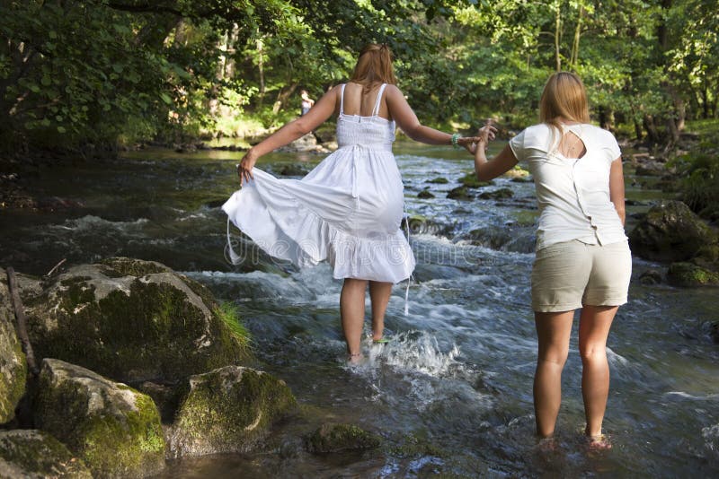 Girls Crossing the Stream stock image. Image of group - 10446495