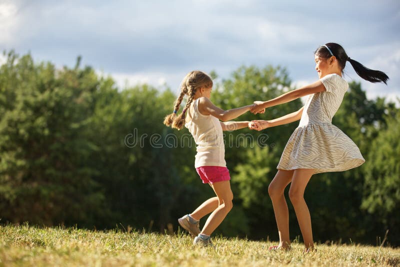 Two Girls Dancing in a Circle Stock Photo - Image of meadow, movement ...