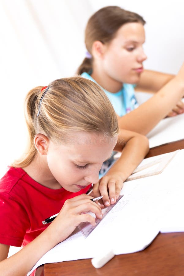 Two Girls Doing Their Homework Stock Photo - Image of cute, concentrate ...
