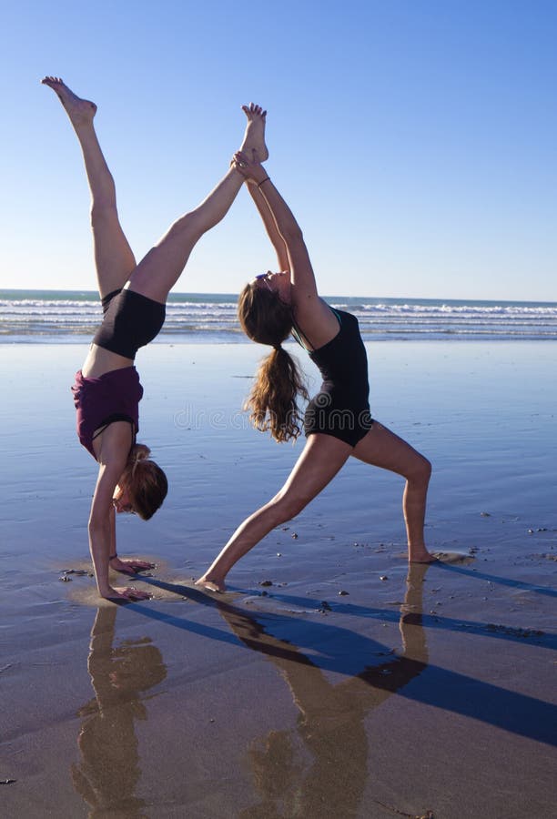 Two girls doing yoga stock photo. Image of fitness, yoga - 67067010