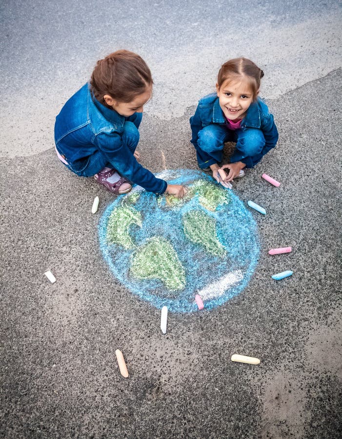 Two Girls Drawing Realistic Earth Image with Chalks on Ground Stock ...