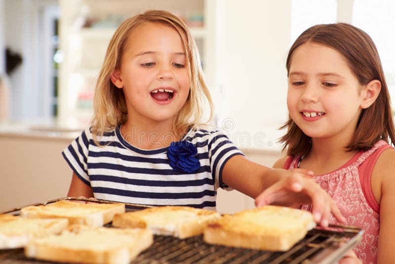 Two Girls Eating Cheese on Toast in Kitchen Stock Image - Image of loaf ...