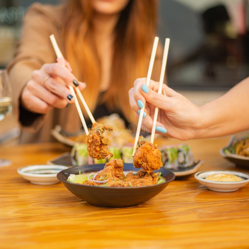 Two Girls Eating in a Sushi Restaurant in Summer Stock Image - Image of ...