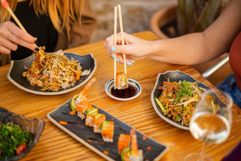 Two Girls Eating in a Sushi Restaurant in Summer Stock Image - Image of ...