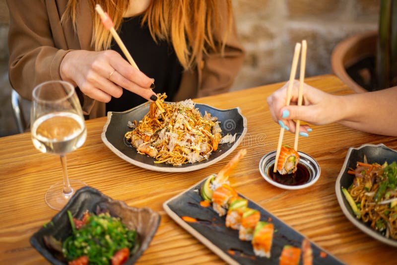 Two Girls Eating in a Sushi Restaurant in Summer Stock Photo - Image of ...