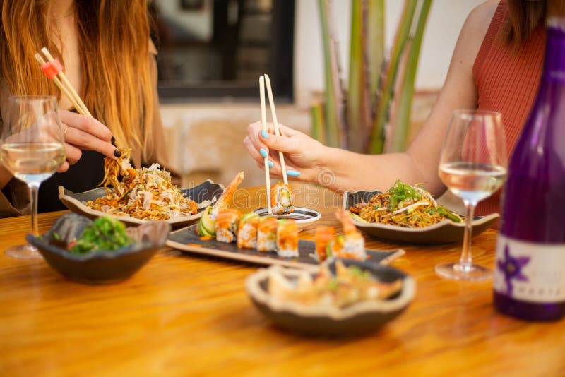 Two Girls Eating in a Sushi Restaurant in Summer Stock Photo - Image of ...