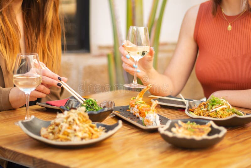 Two Girls Eating in a Sushi Restaurant in Summer Stock Image - Image of ...