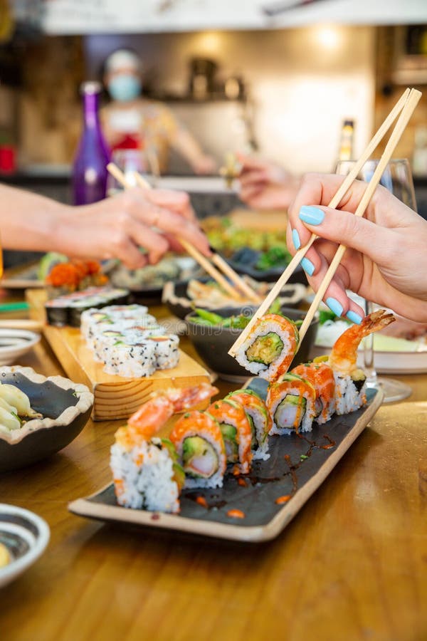 Two Girls Eating in a Sushi Restaurant in Summer Stock Image - Image of ...