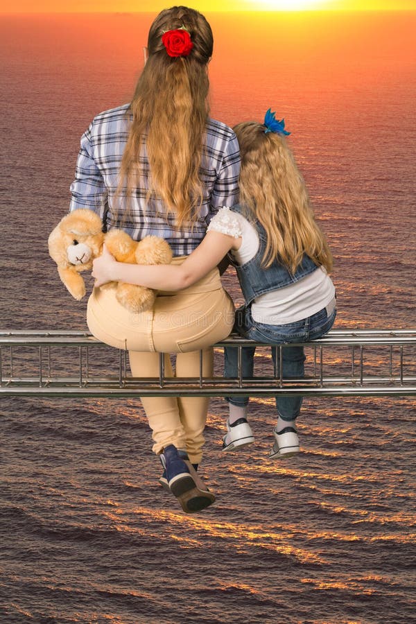 Two Girls Embracing Sitting on the Beam Stock Image - Image of girl ...