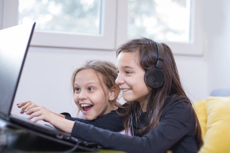 Two Girls Enjoying Using Internet on Laptop Stock Photo - Image of ...