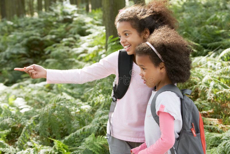 Two Girls Exploring Woods Together Stock Photo - Image of packs, forest ...