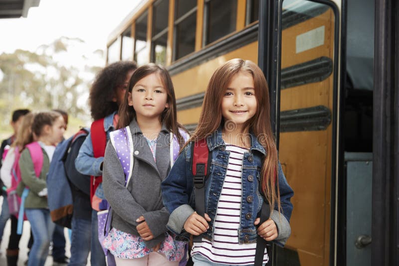 Two Girls at the Front of the Elementary School Bus Queue Stock Photo ...