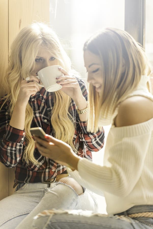 Two Girls Having Fun while Drinking Coffee Stock Photo - Image of ...