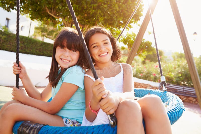 Two Girls Having Fun on Swing in Playground Stock Image - Image of ...