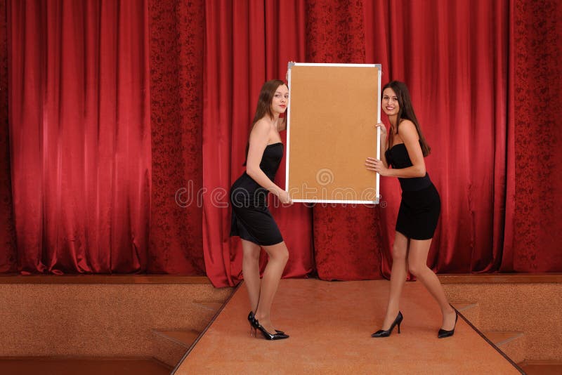 Two girls hold empty board stock photo. Image of hold - 22956616