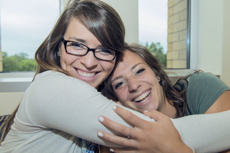 Two girls hug each other stock photo. Image of close - 57377180