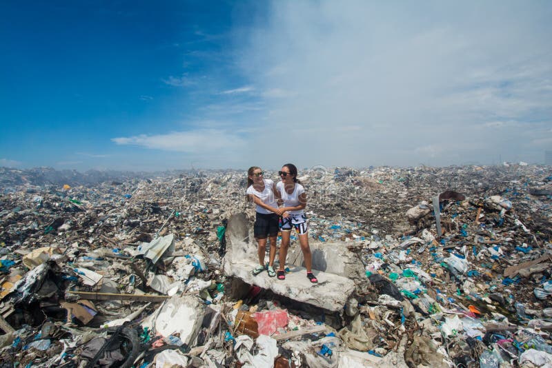 Two Girls Walking among Trash at Garbage Dump Stock Image - Image of ...