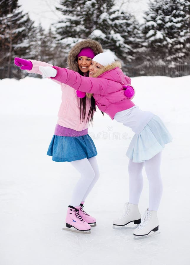 Two girls ice skating stock photo. Image of hold, relations - 12052312