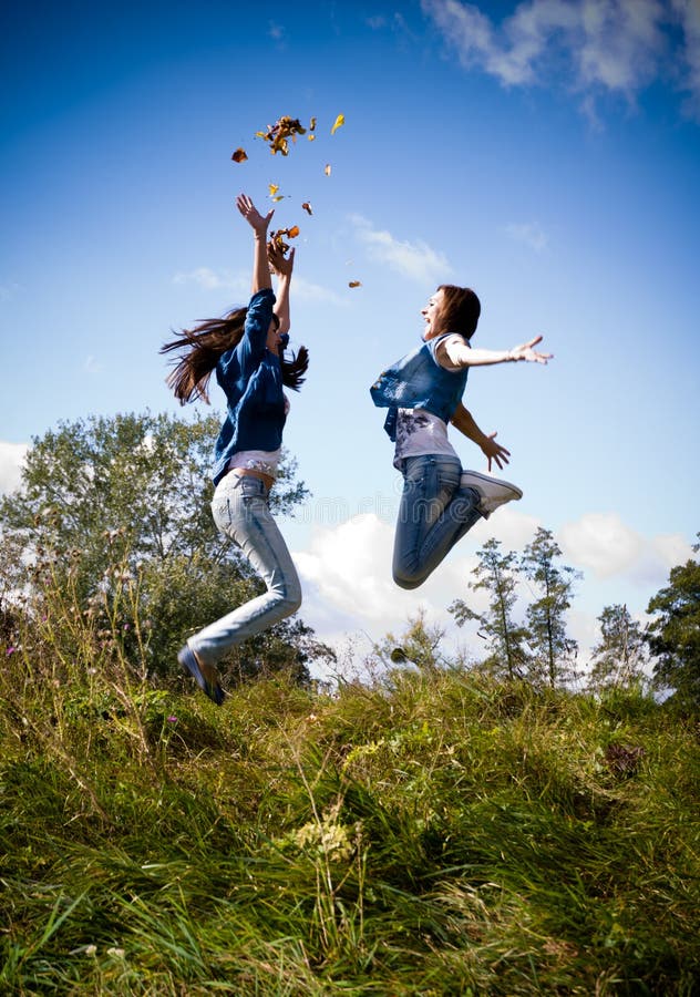 Two Girls Jumping High Excited Stock Photo - Image of hands, fall: 21451882