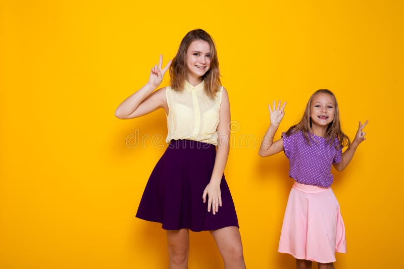 Two Girls Laughing Show Fingers Stock Image - Image of greeting, cheer ...