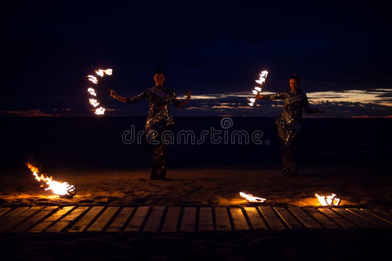Two Girls Light a Sparkler on the Beach at Dusk Stock Photo - Image of ...