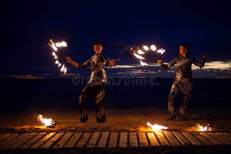 Two Girls Light a Sparkler on the Beach at Dusk Stock Image - Image of ...