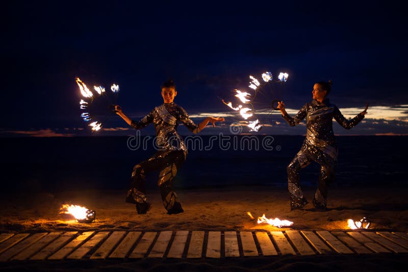 Two Girls Light a Sparkler on the Beach at Dusk Stock Image - Image of ...