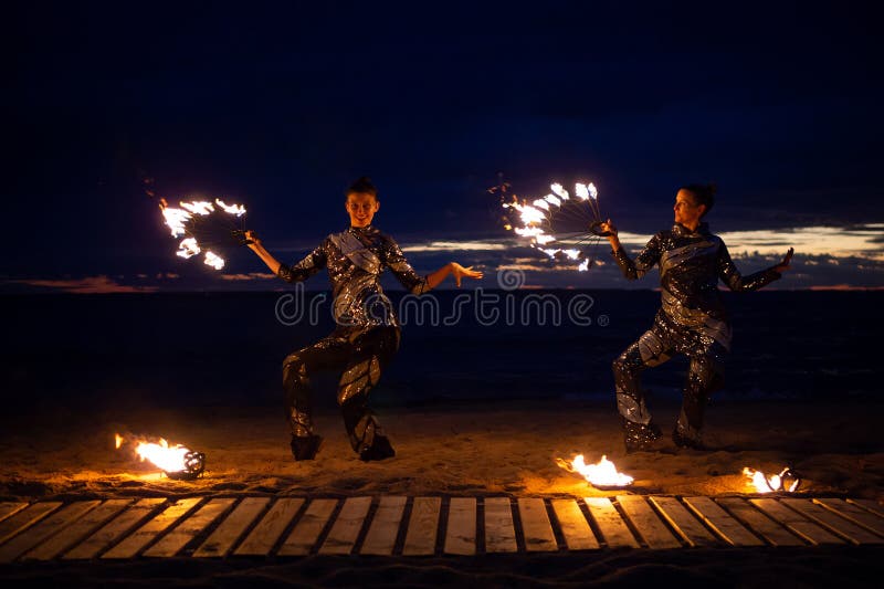 Two Girls Light a Sparkler on the Beach at Dusk Stock Photo - Image of ...