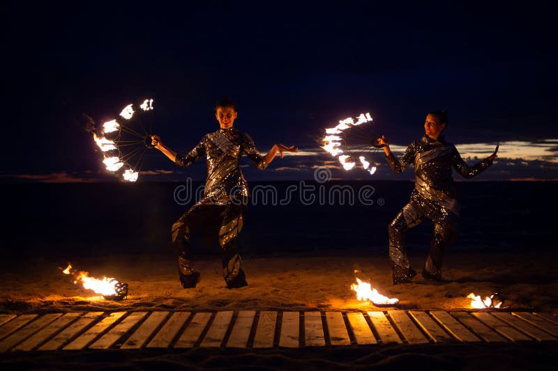 Two Girls Light a Sparkler on the Beach at Dusk Stock Photo - Image of ...