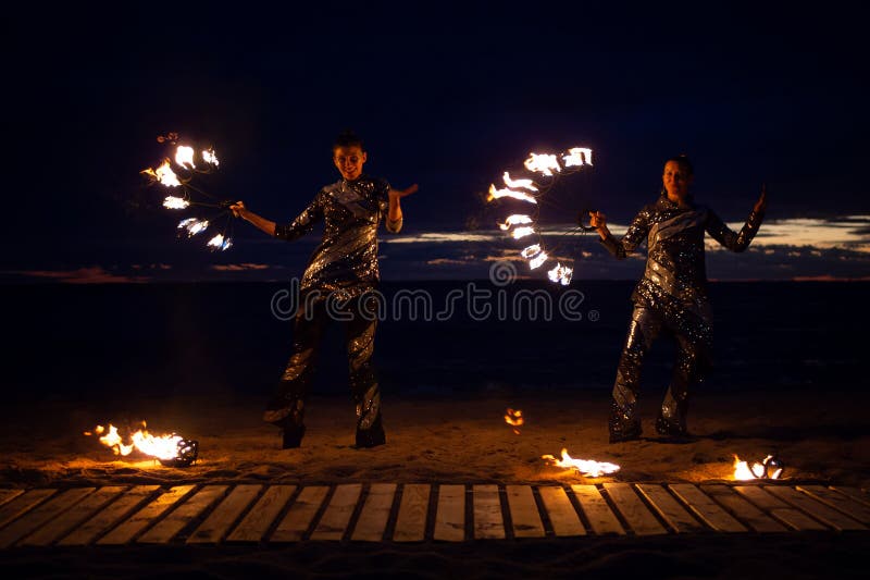 Two Girls Light a Sparkler on the Beach at Dusk Stock Image - Image of ...