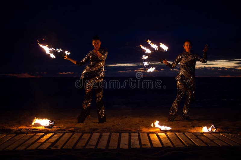 Two Girls Light a Sparkler on the Beach at Dusk Stock Photo - Image of ...