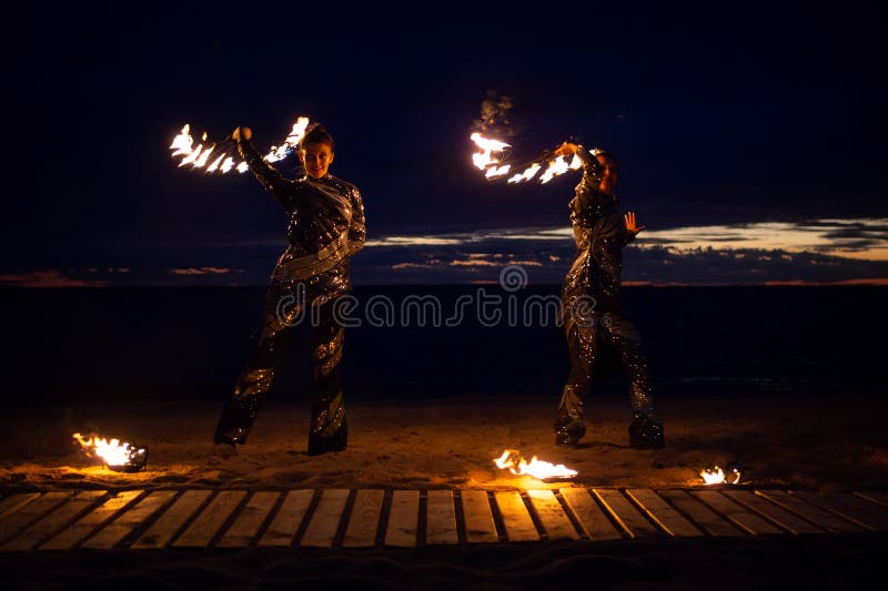 Two Girls Light a Sparkler on the Beach at Dusk Stock Photo - Image of ...