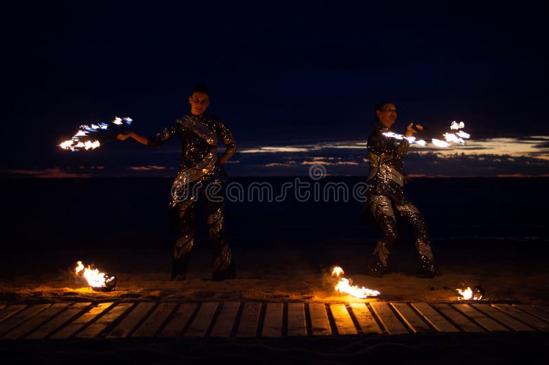 Two Girls Light a Sparkler on the Beach at Dusk Stock Photo - Image of ...