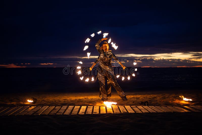 Two Girls Light a Sparkler on the Beach at Dusk Stock Photo - Image of ...