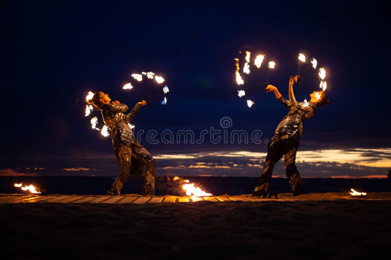 Two Girls Light a Sparkler on the Beach at Dusk Stock Image - Image of ...