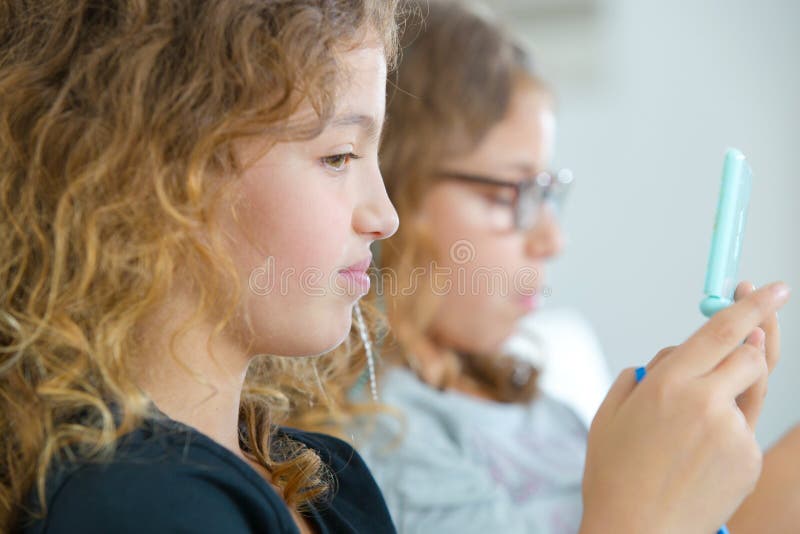 Two girls look on phone stock image. Image of adult - 100430629