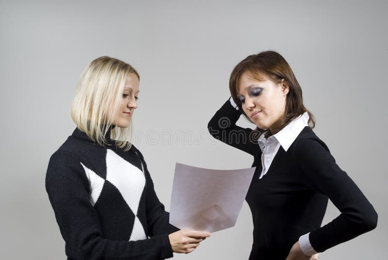 Two Girls Looking at the Paper Stock Photo - Image of carrying ...