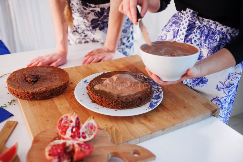 Two Girls Making a Cake on the Kitchen. Womens Hands, Causing the ...