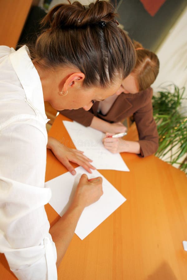 Two girls making notes stock photo. Image of close, talk - 995082