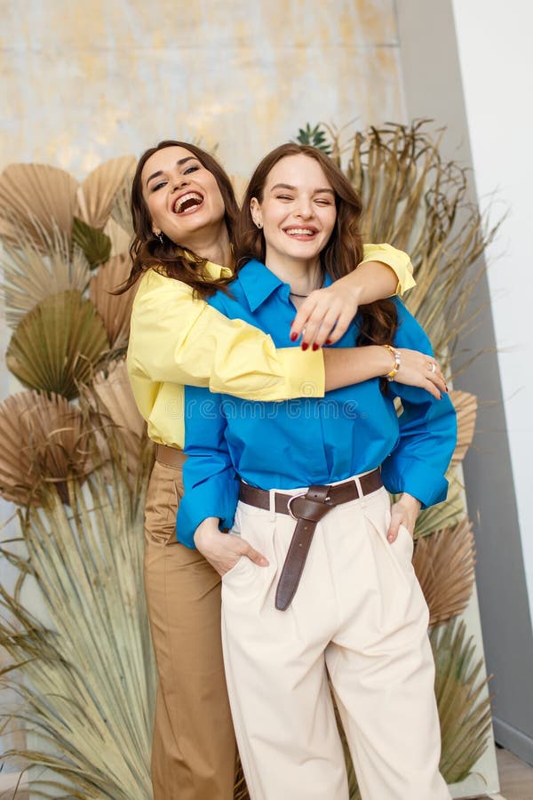 Two Girls, Models, Have Fun and Smile in a Photo Studio. Expression of ...