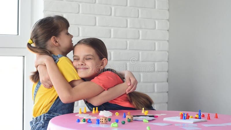 Two Girls Play Board Games and Hug Each Other Stock Video - Video of ...