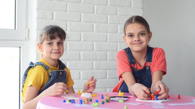 Two Girls Play Board Games and Have Fun Looking at the Frame Stock ...
