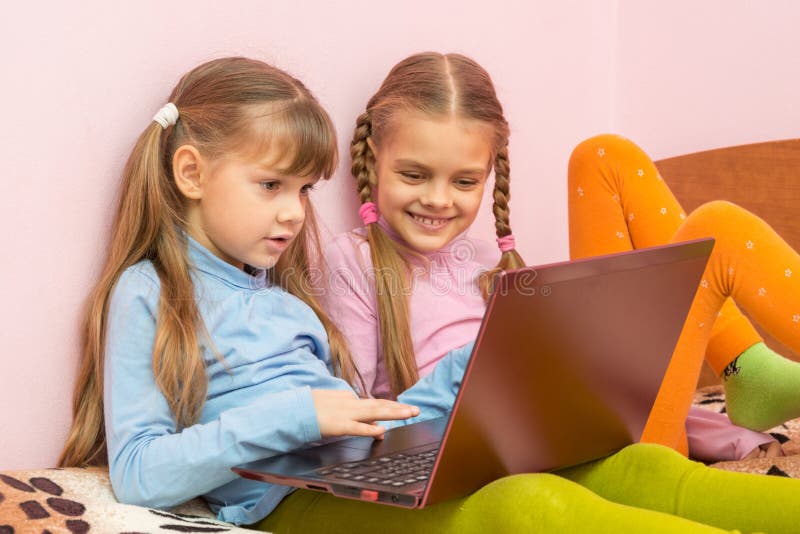 Two Girls Play Computer Games on Laptop Stock Photo - Image of pastime ...