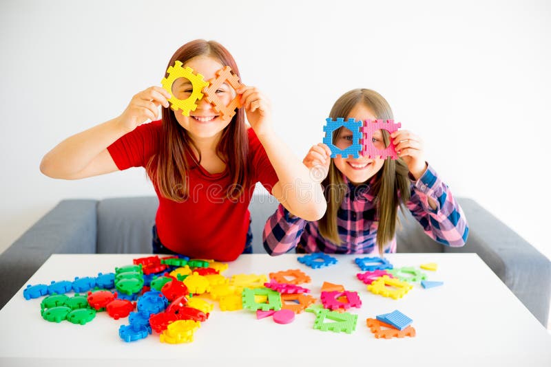 Two girls playing lego stock photo. Image of colorful - 95144388