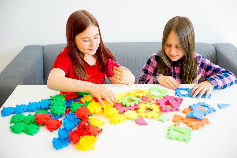 Two girls playing lego stock photo. Image of education - 95144464