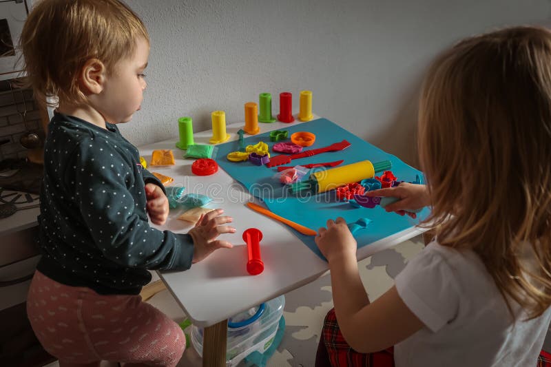 Two Girls Playing with Playdough at the Table. Stock Image - Image of ...