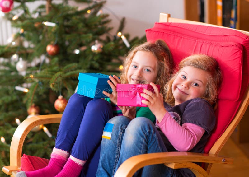 Two Girls with Presents in Front of Christmas Tree Stock Image - Image ...